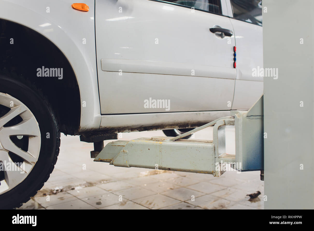 Car raised on car lift in autoservice Stock Photo - Alamy