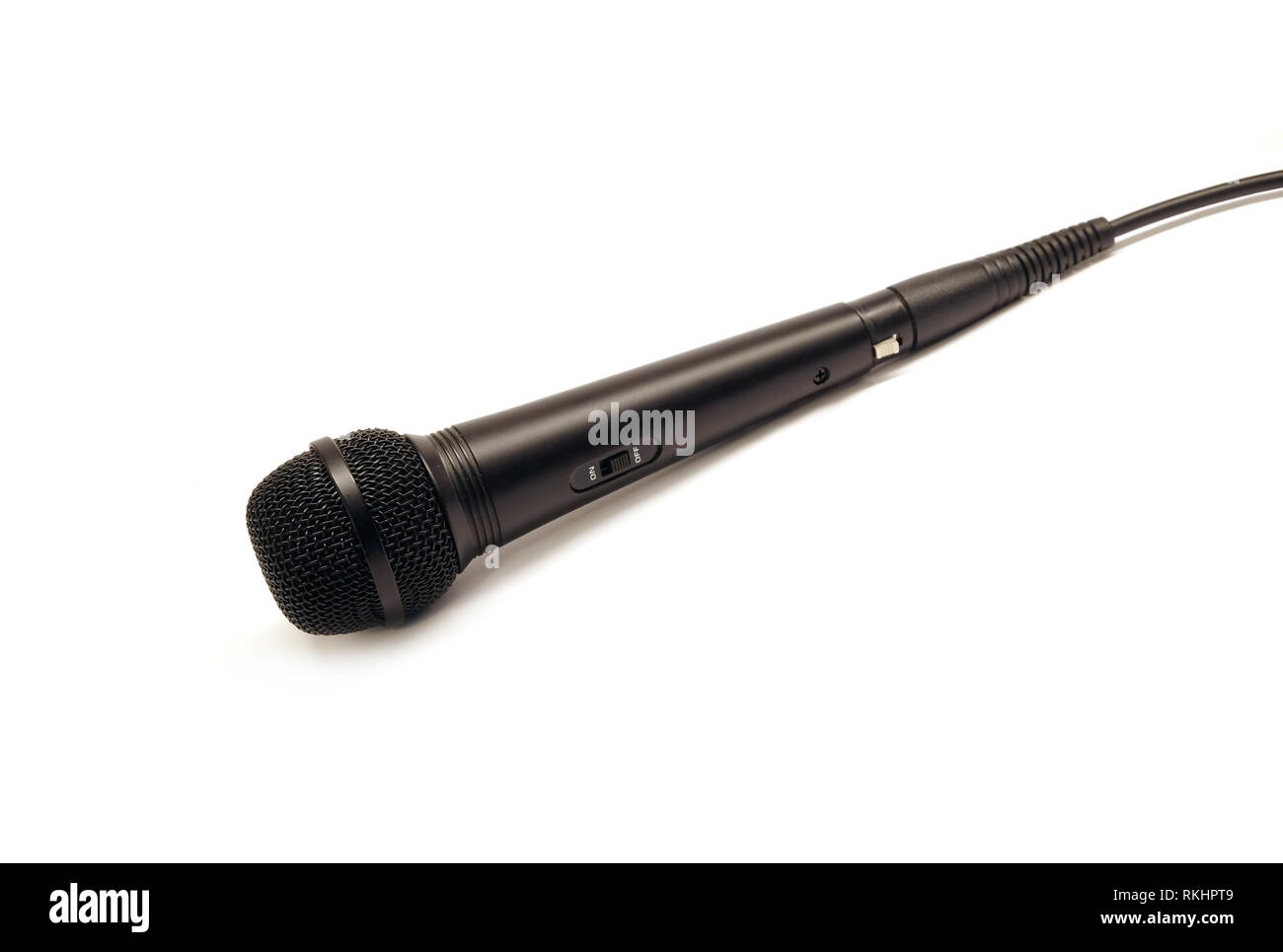 Black vocal microphone with on button on body and wire isolated on ...