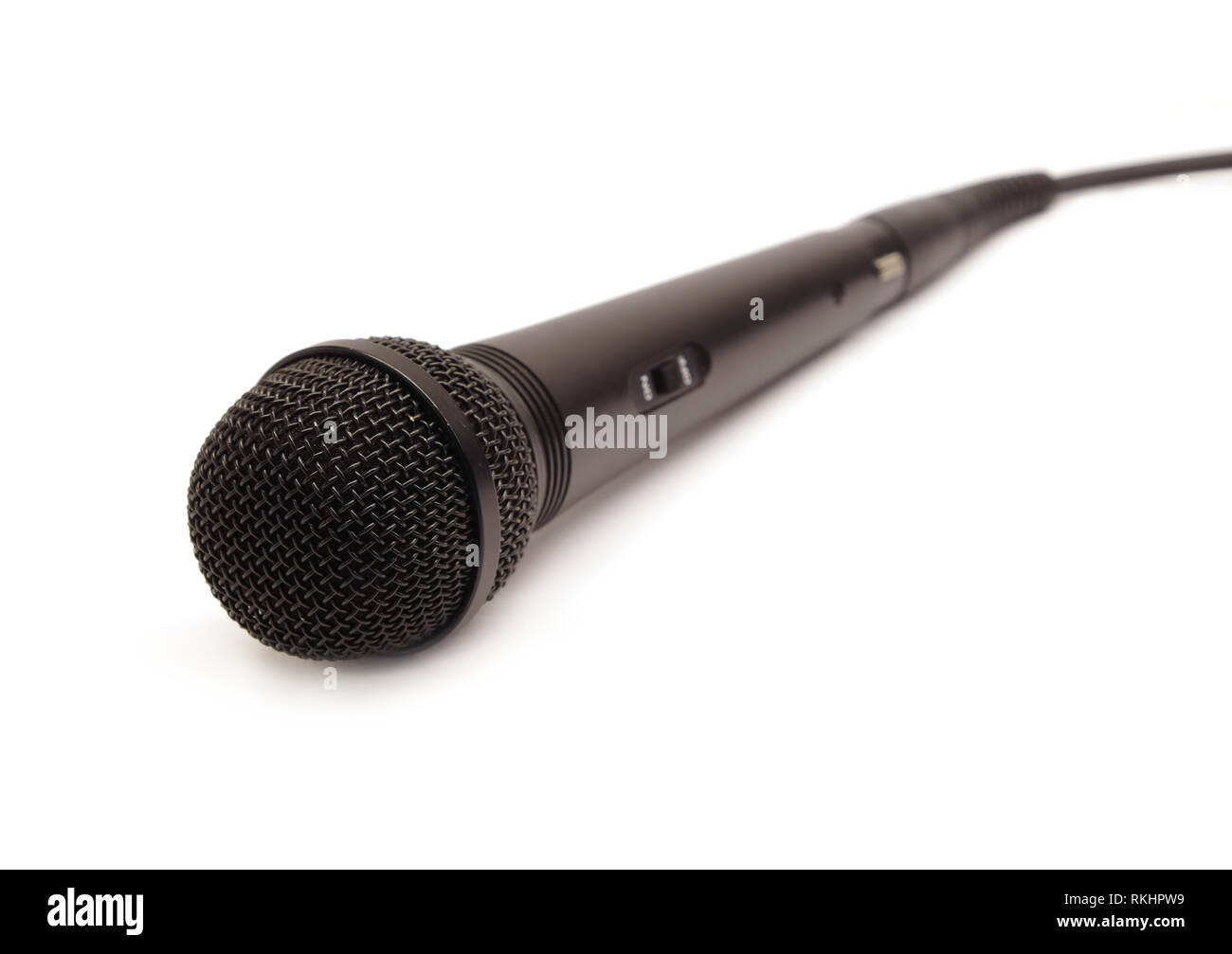 Long black studio vocal microphone with on button on body and wire ...