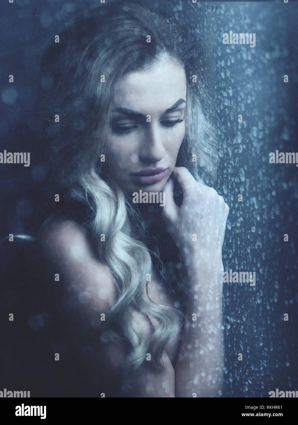 Woman behind glass with drops of water hi-res stock photography and ...