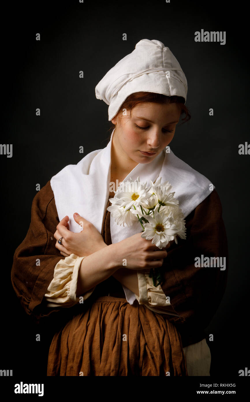 Medieval maid holding flowers Stock Photo - Alamy
