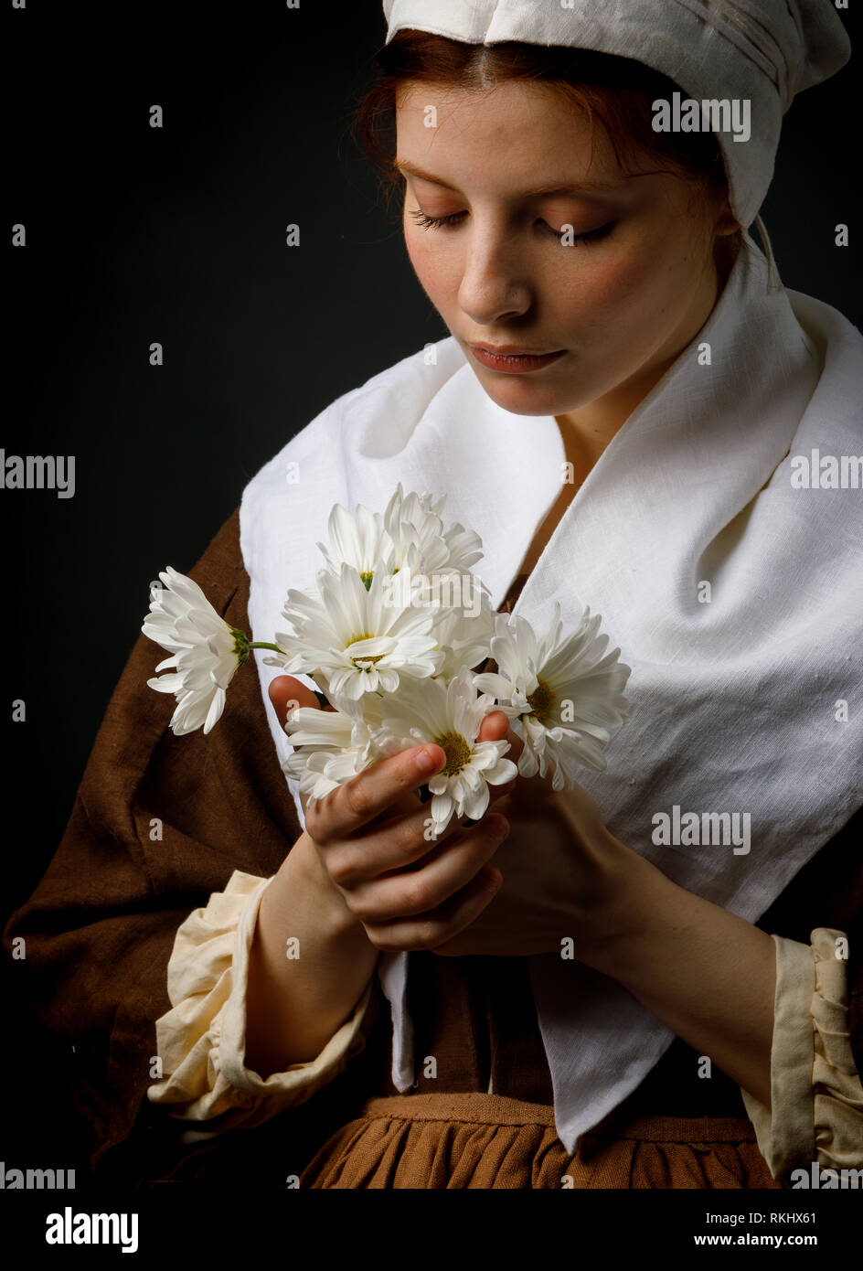Medieval maid holding flowers Stock Photo - Alamy