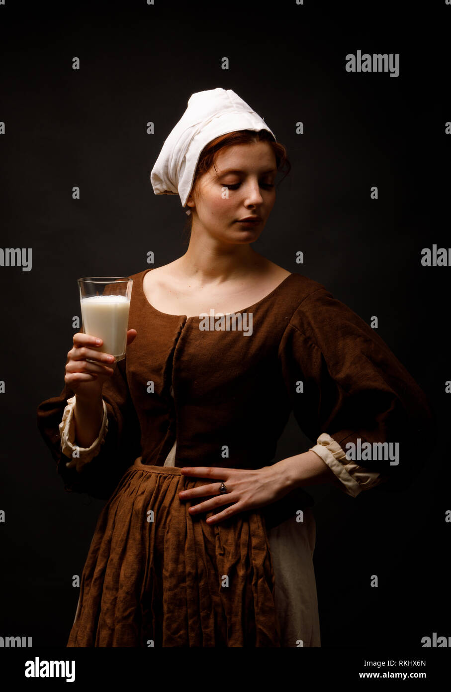 Medieval maid with glass of milk Stock Photo - Alamy