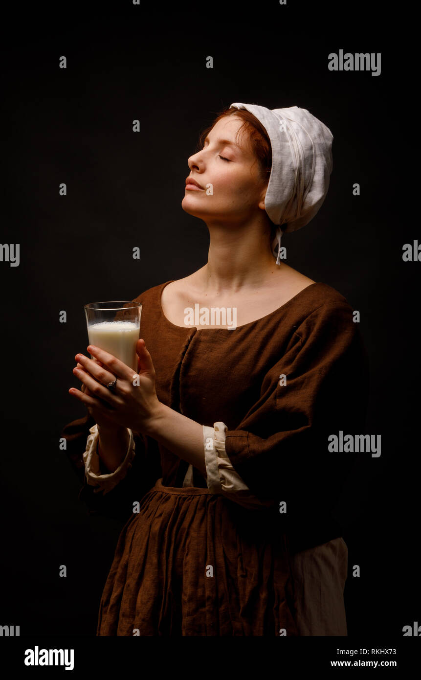 Medieval maid with glass of milk Stock Photo - Alamy
