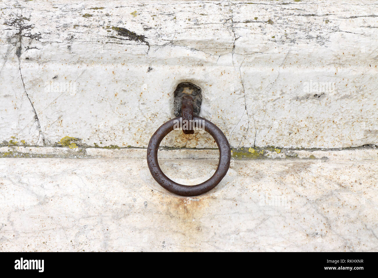 Metal ring placed in a stone wall - safety concept Stock Photo - Alamy