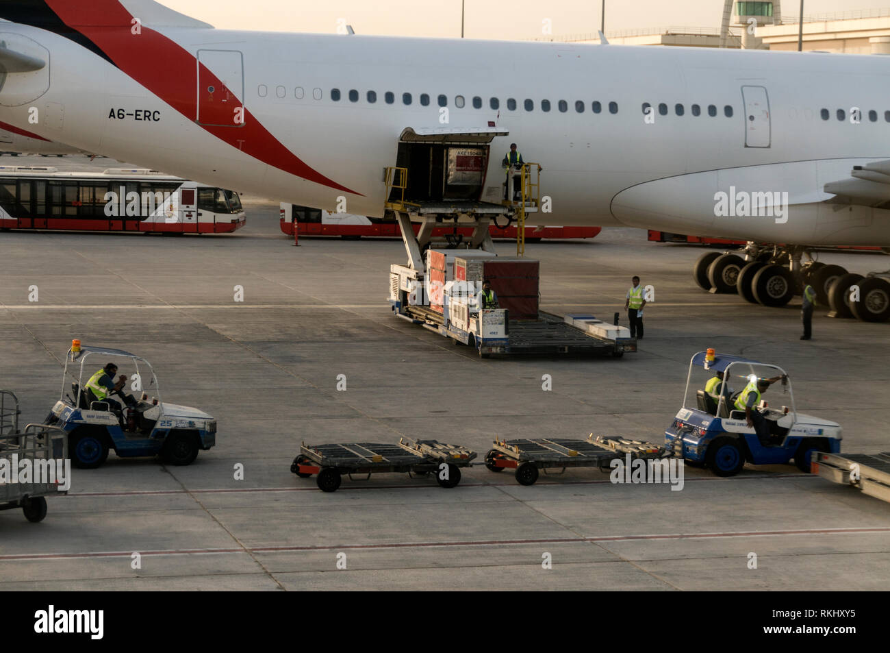 Ground crew loading cargo on board one of the Emirates passenger ...