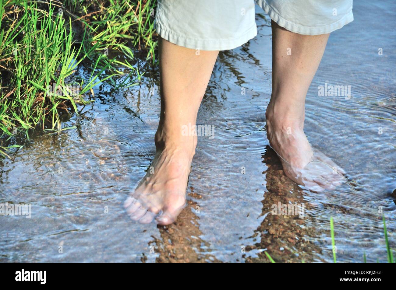 Woman walking into water hi-res stock photography and images - Alamy