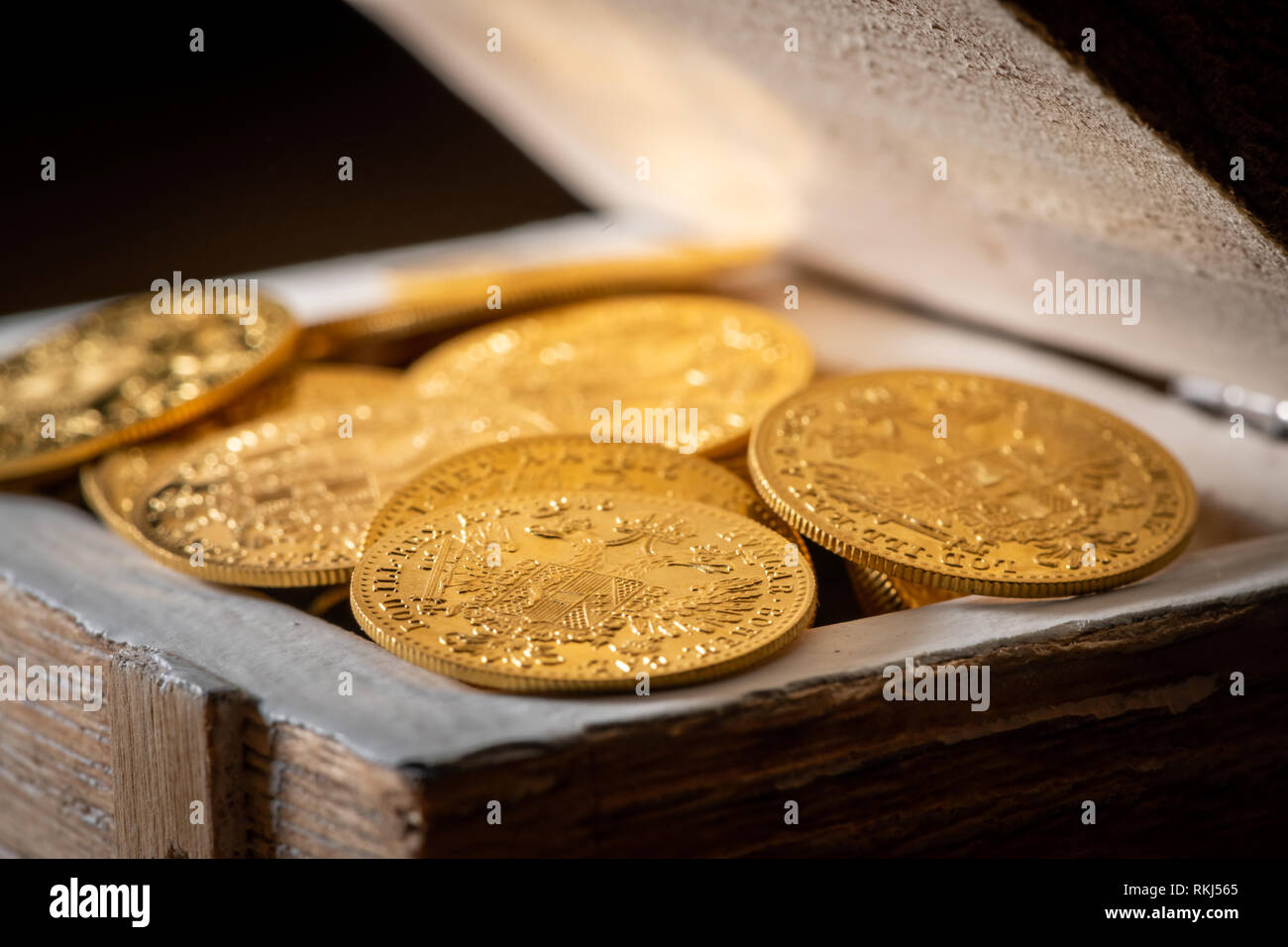 Shiny gold coins (Austrian ducats) in a small wooden treasure box Stock ...