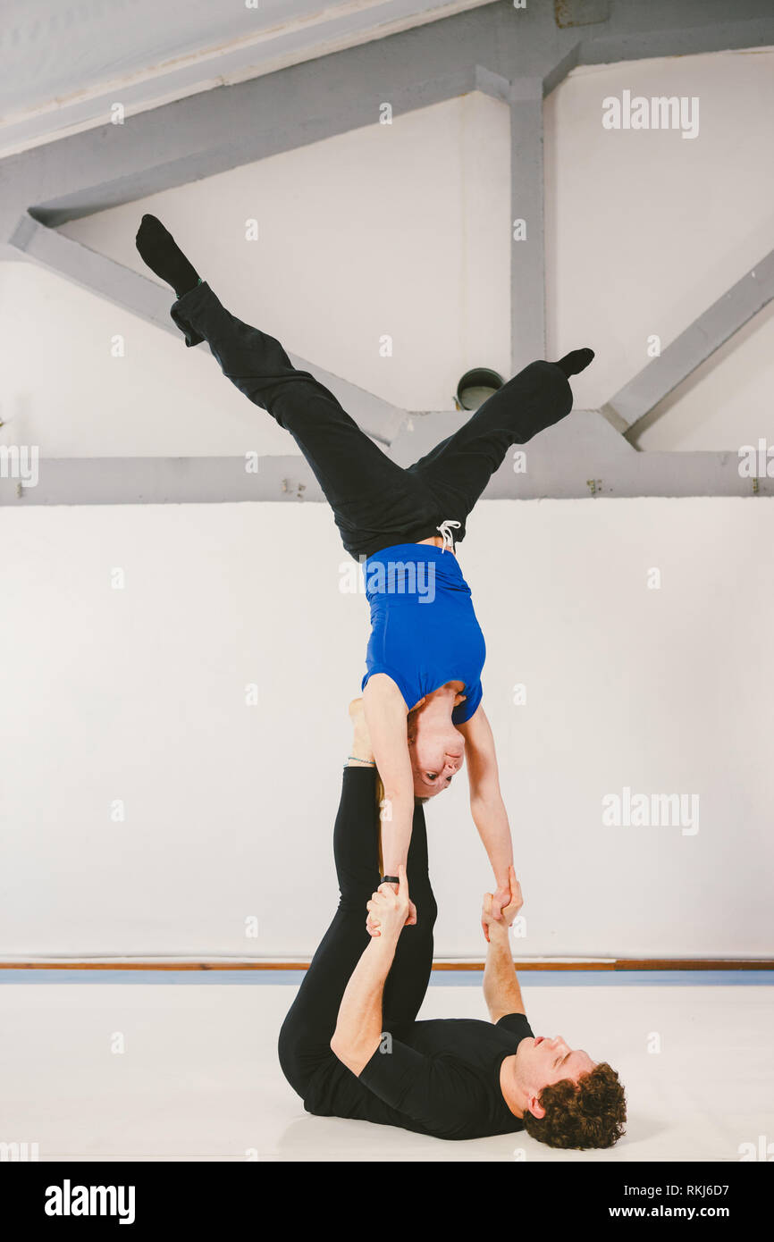 Strong acrobatic woman lifting man hi-res stock photography and images ...