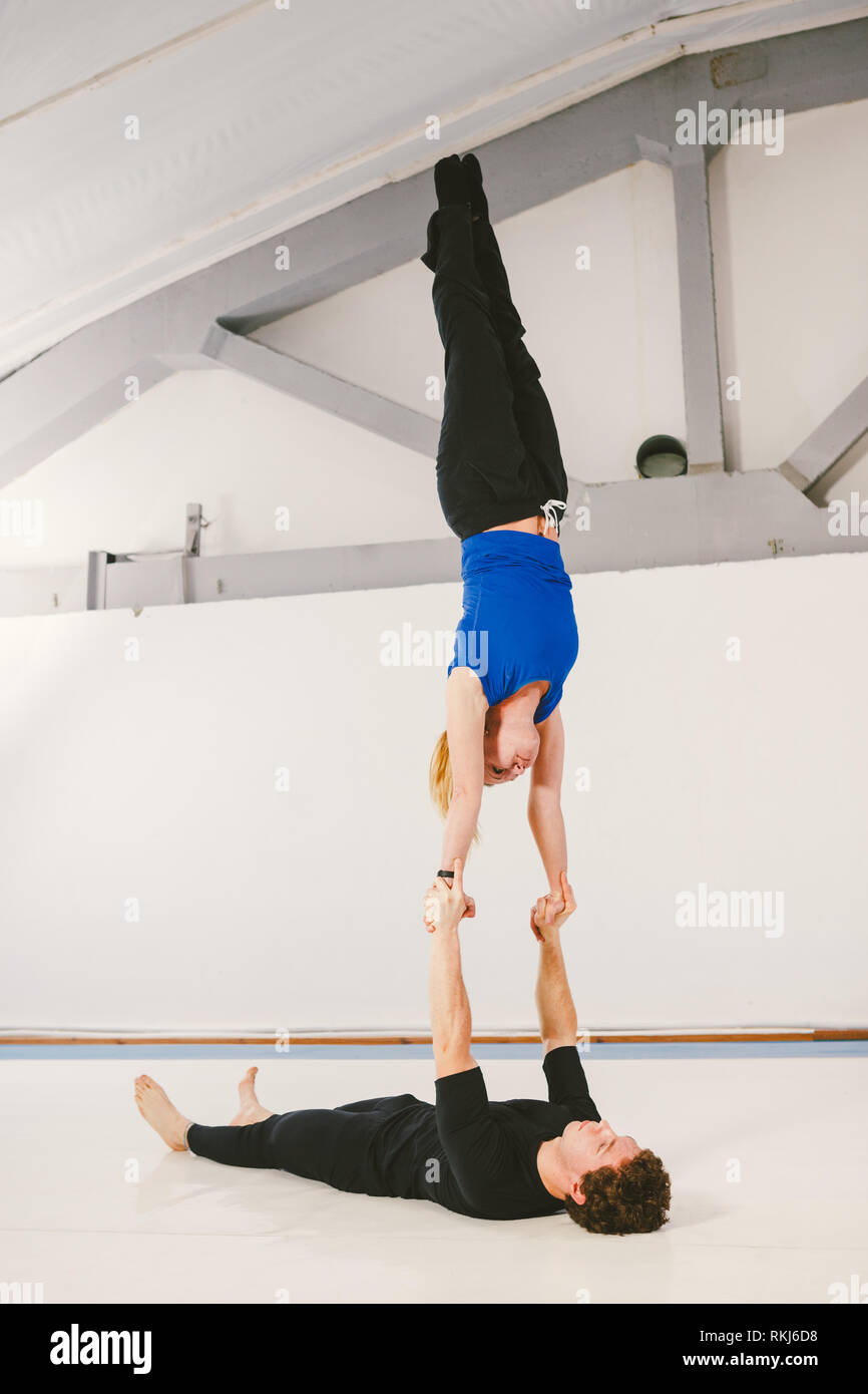 Strong acrobatic woman lifting man hi-res stock photography and images ...