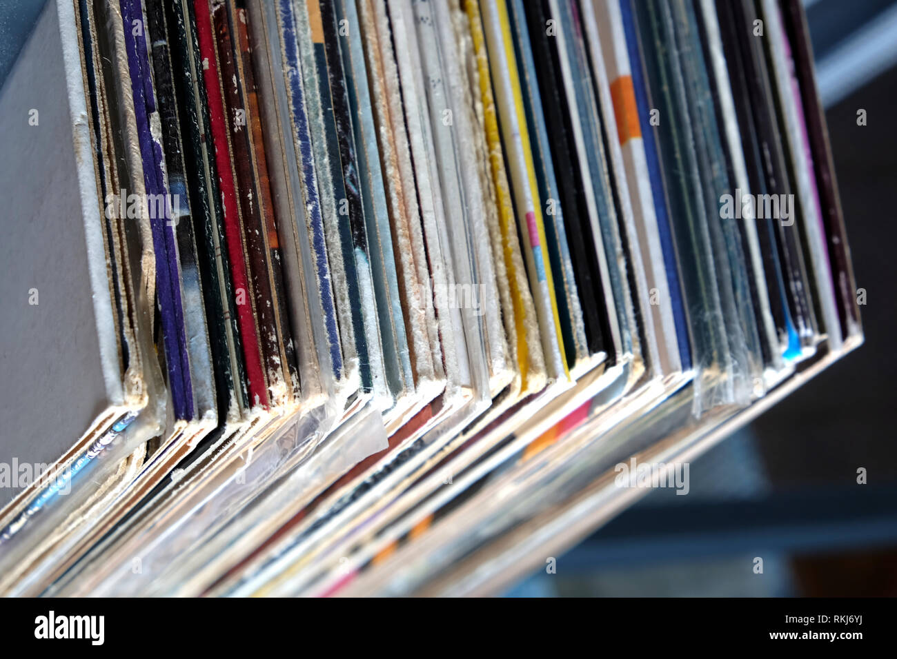 Pile of many close standing vinyl records in old color covers on a ...