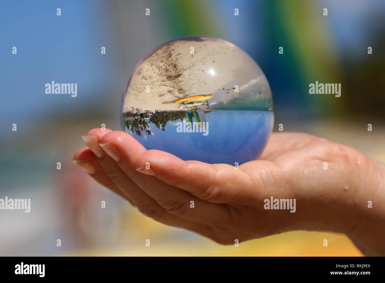 Glass ball. Beach through a glass ball Stock Photo - Alamy
