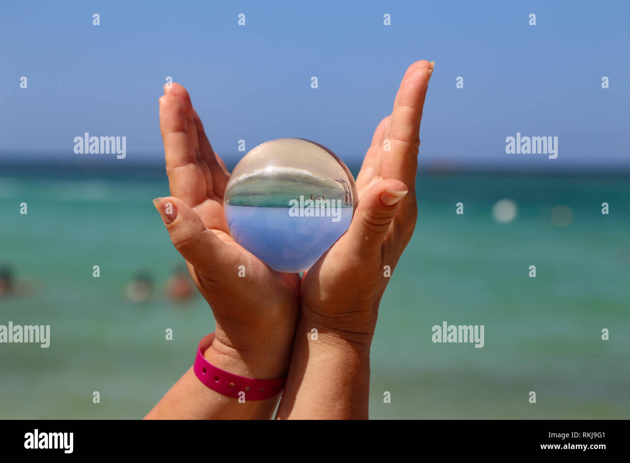 Glass ball. Beach through a glass ball Stock Photo - Alamy