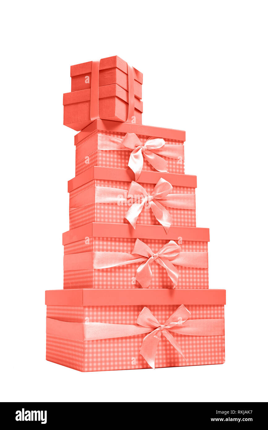 stack of coral gift boxes with satin ribbons on white background Stock ...