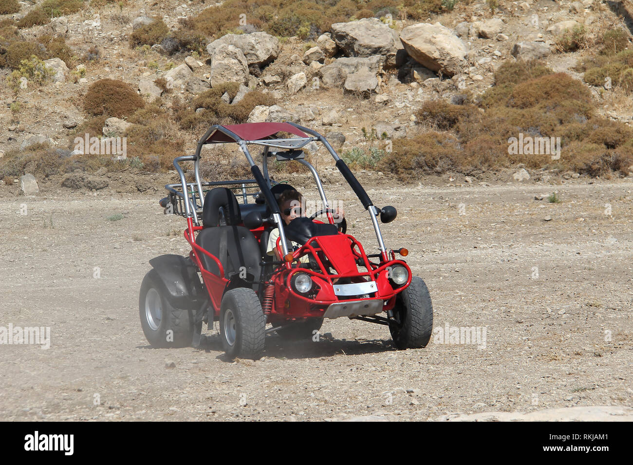 Sport / A young man controls a buggy Stock Photo - Alamy