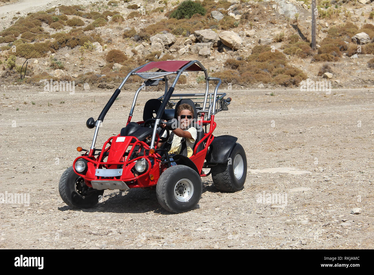 Sport / A young man controls a buggy Stock Photo - Alamy