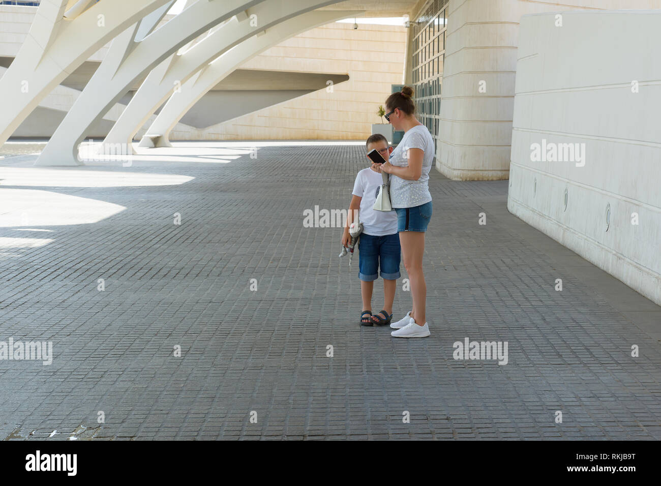 the mother is trying to explain something to her son Stock Photo - Alamy