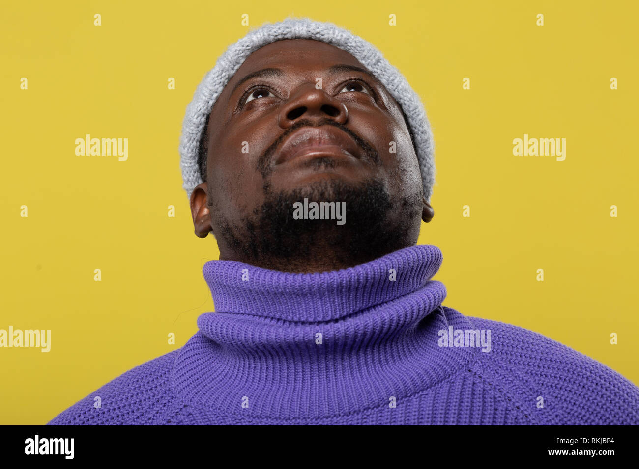 Concentrated bearded man raising his head upwards Stock Photo - Alamy