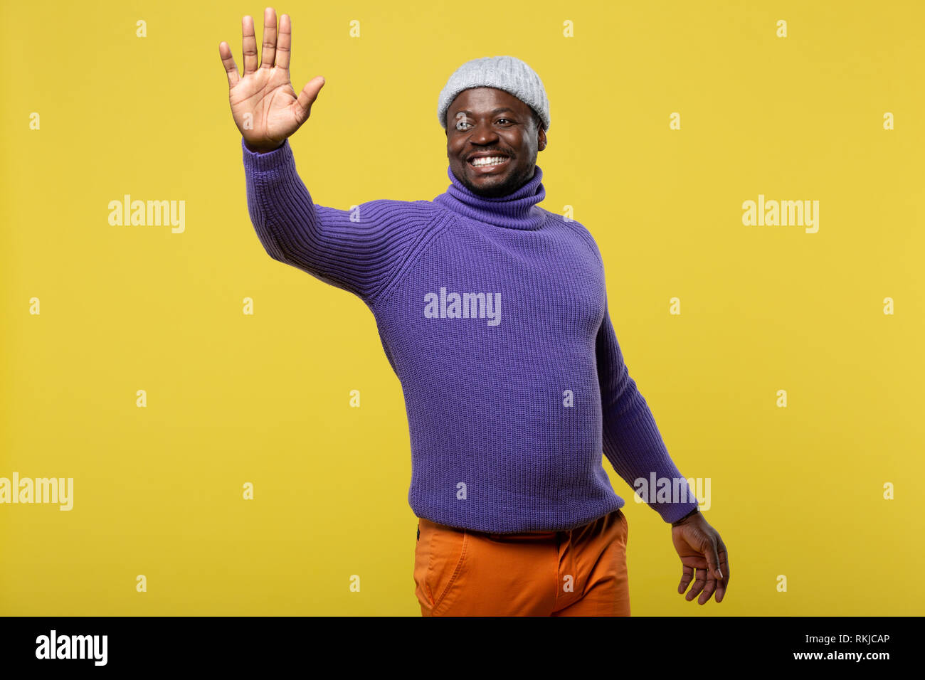 Positive delighted international man welcoming his friend Stock Photo ...