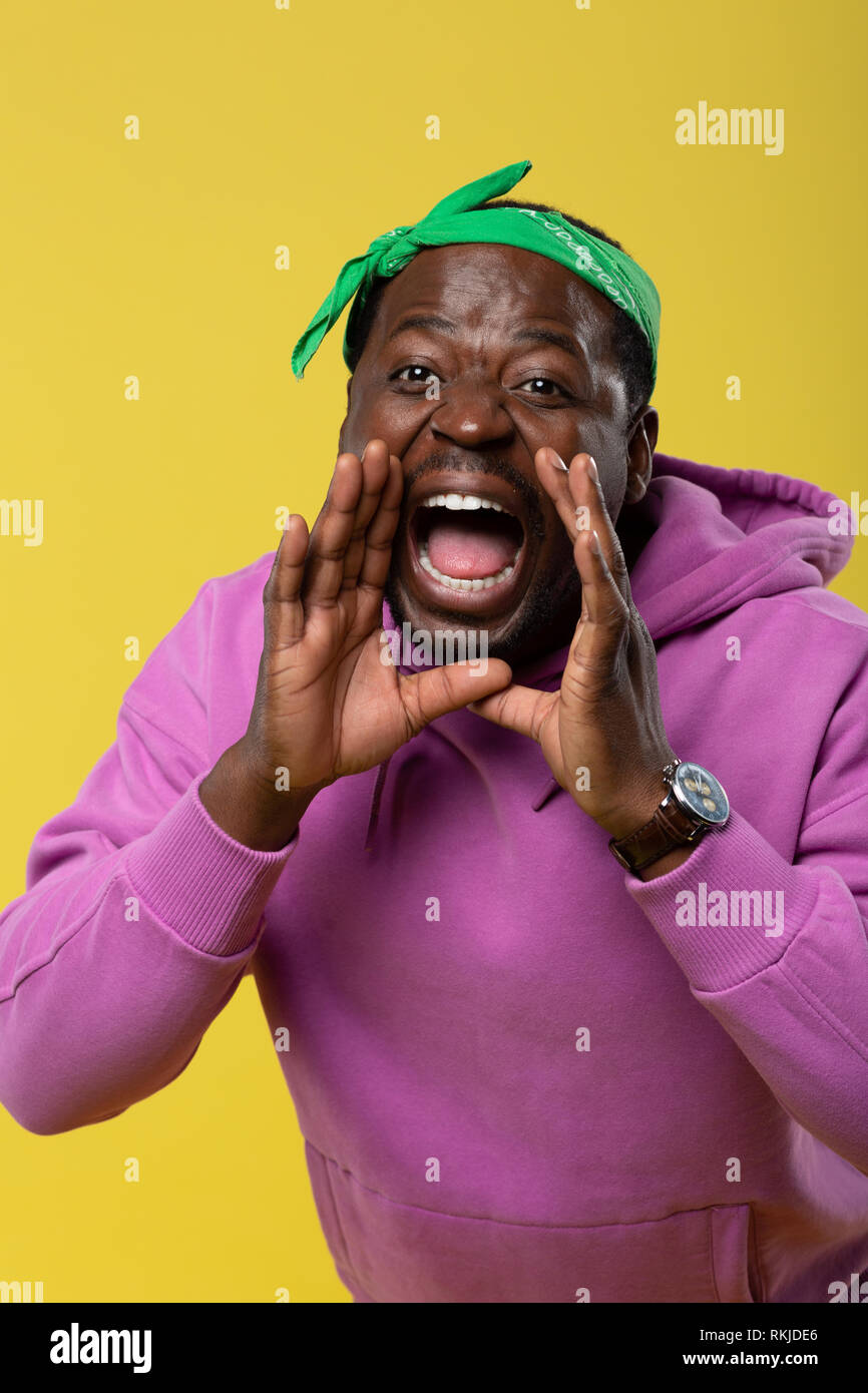 Positive delighted male person shouting on camera Stock Photo - Alamy