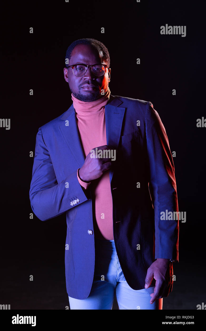 Pleased young businessman posing before his photographer Stock Photo ...