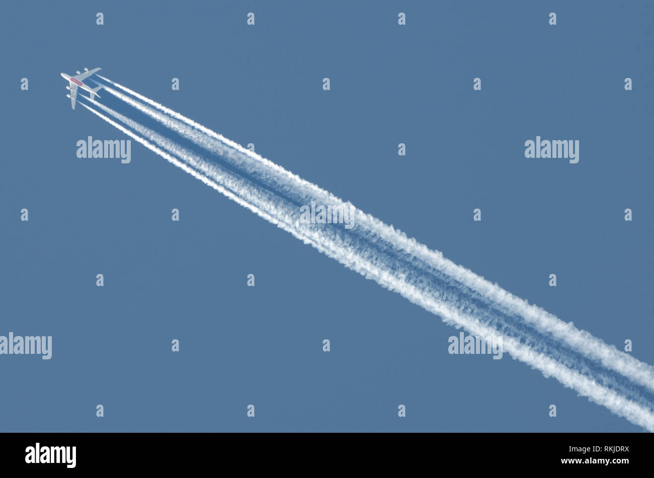 the aircraft is in high speed flying in the sky,leaving a trail Stock ...