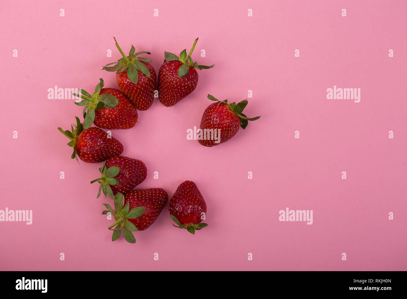Strawberries on pink background teamwork concept Stock Photo - Alamy