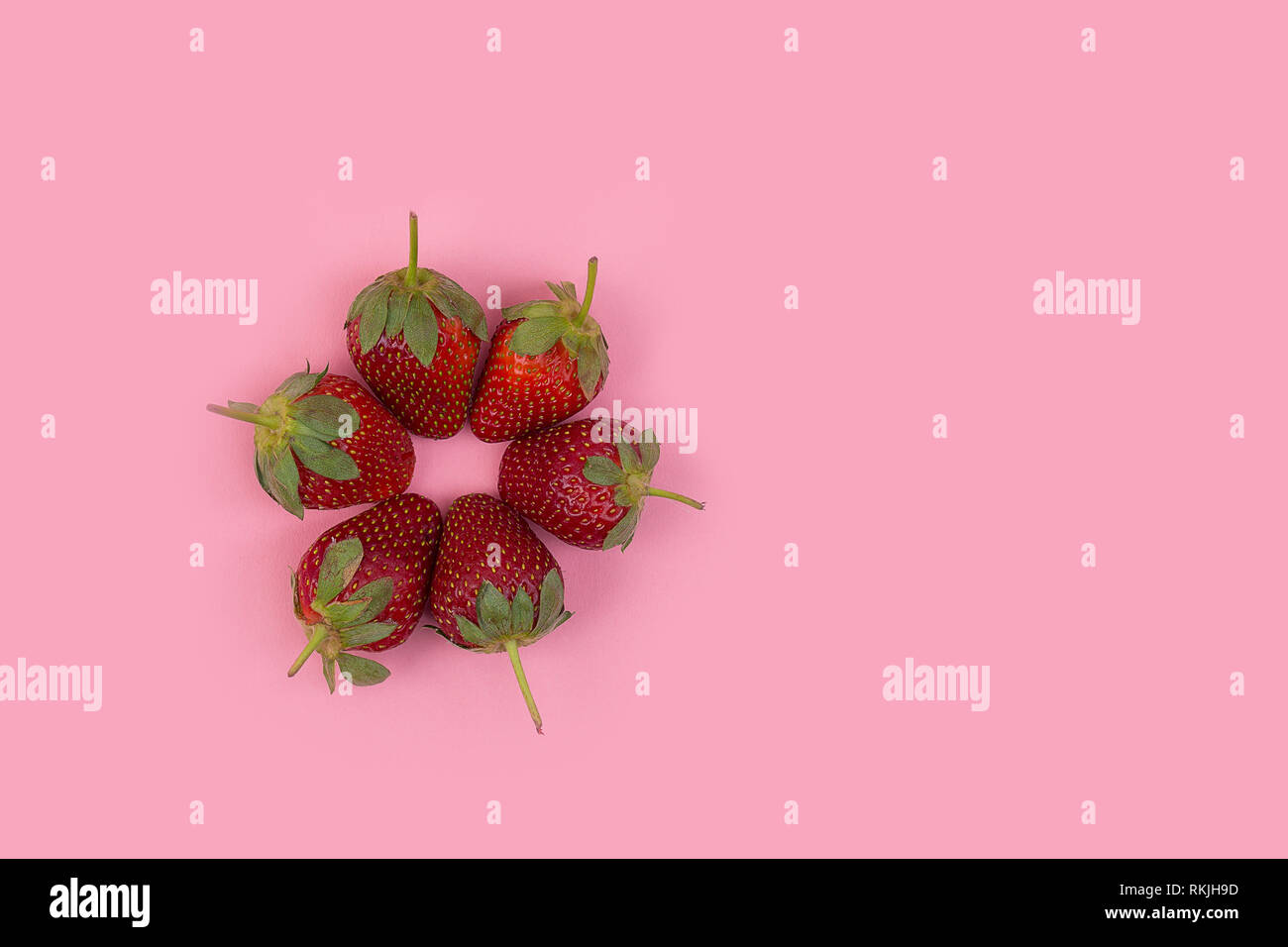 Strawberries on pink background teamwork concept Stock Photo - Alamy