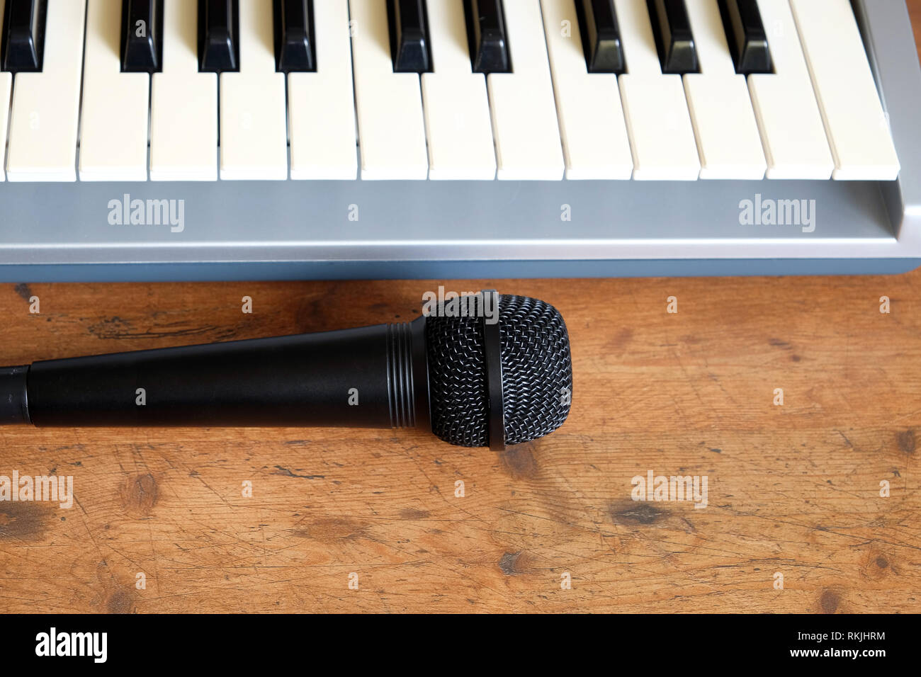 Black voice microphone and electronic synthesizer keyboard in silver ...