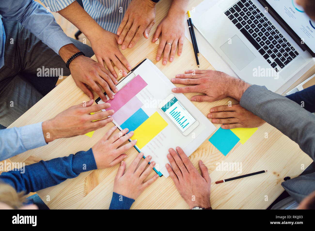 A top view of group of businesspeople with smartphone working together ...