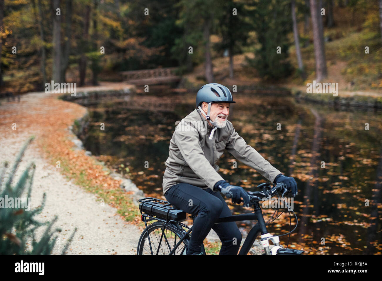 Old man on bike by river hi-res stock photography and images - Alamy