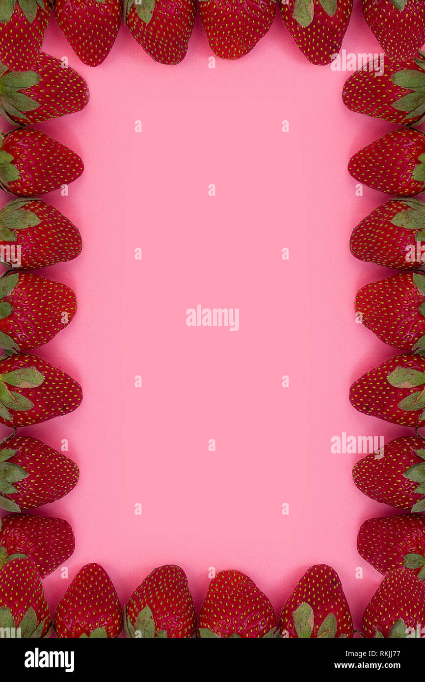 frame made of strawberries with pink background Stock Photo - Alamy