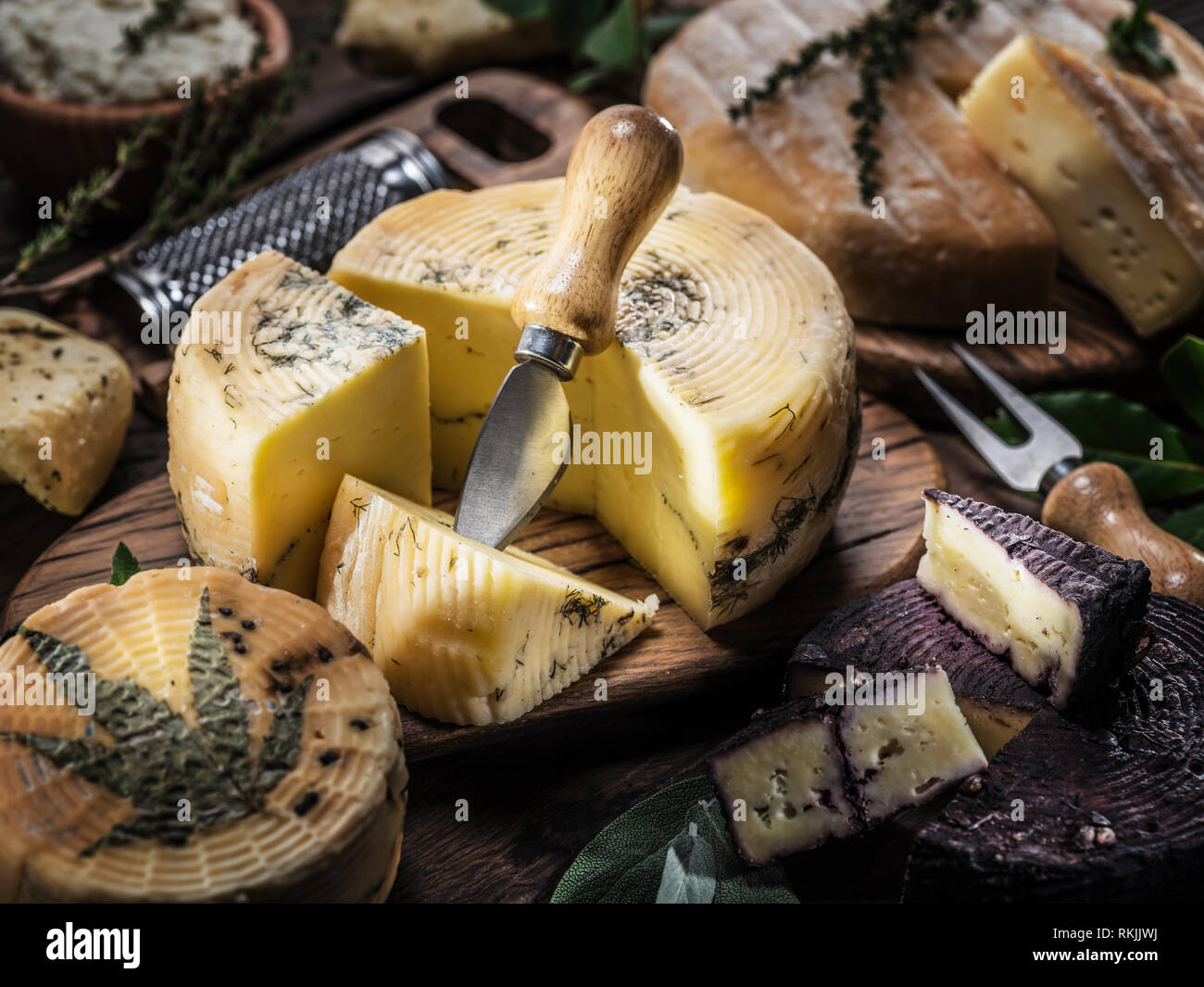 Homemade cheeses on the wooden background. Cheese background Stock ...