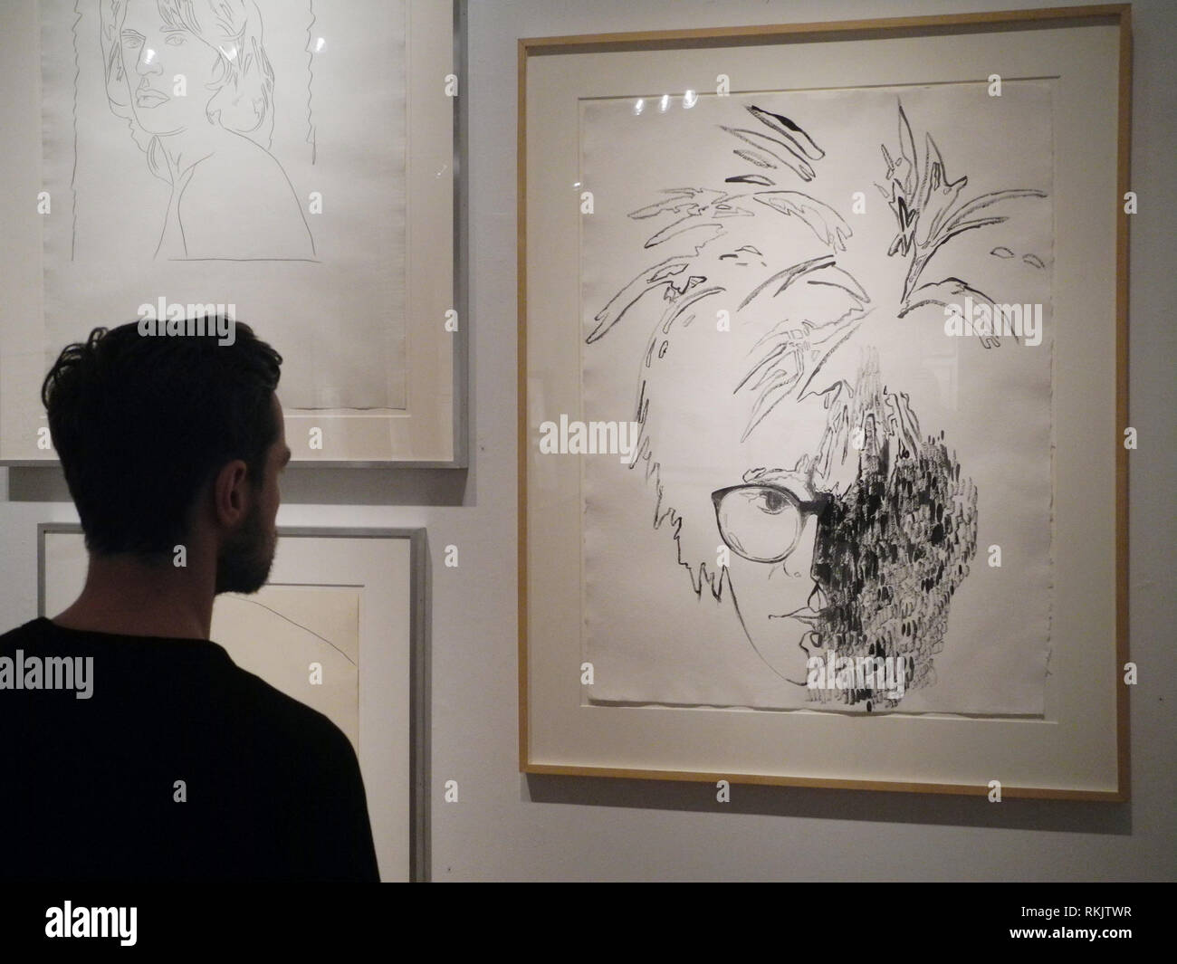 New York, USA. 24th Jan, 2019. A visitor stands before a self-portrait ...