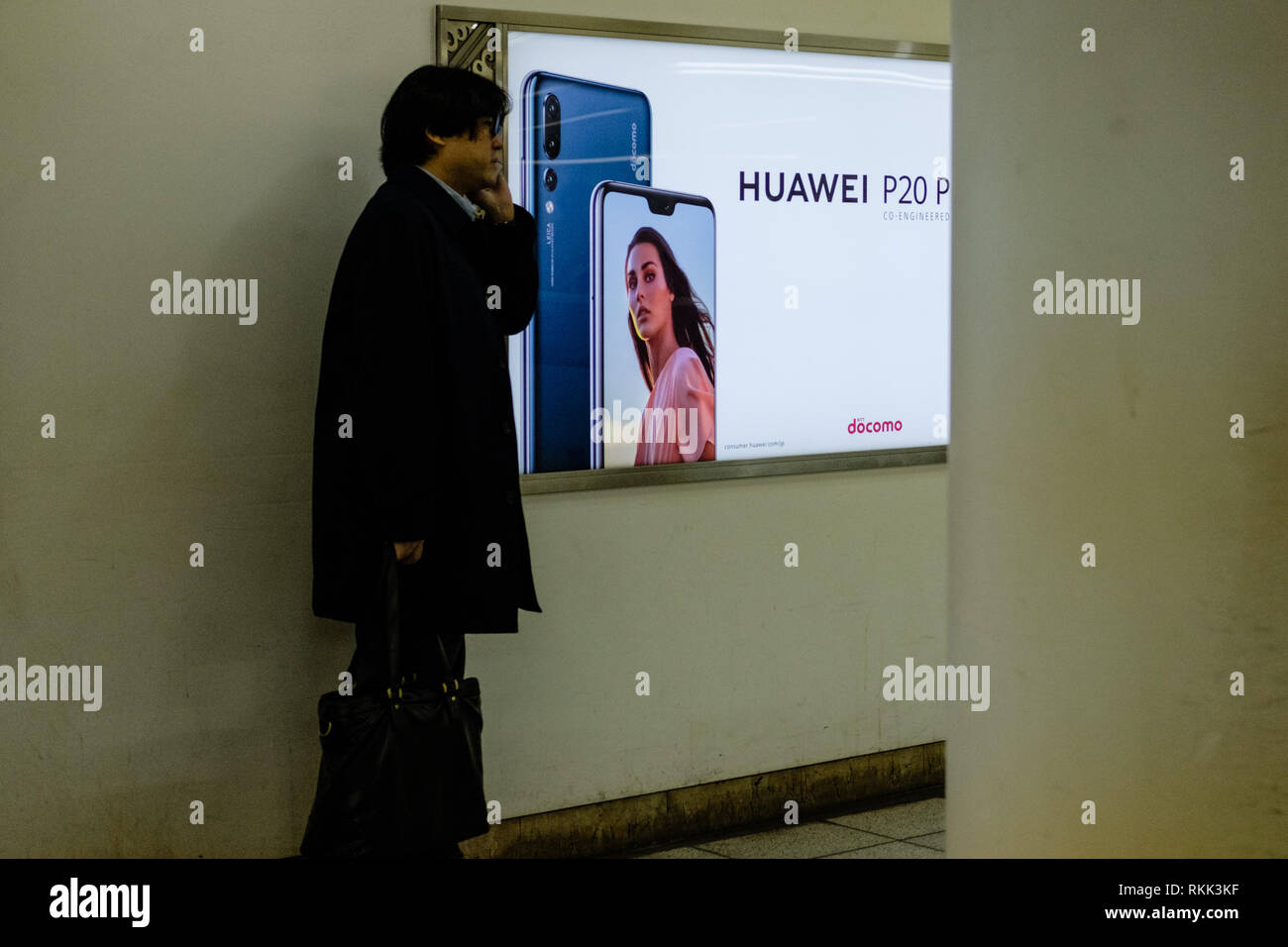 Tokyo, Japan. 12th Feb, 2019. A man talks on the phone by a Chinese ...