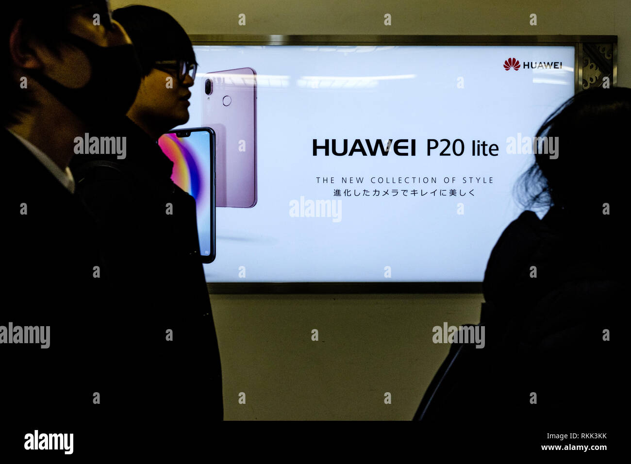 Tokyo, Japan. 12th Feb, 2019. People walk by a Chinese telecom giant ...