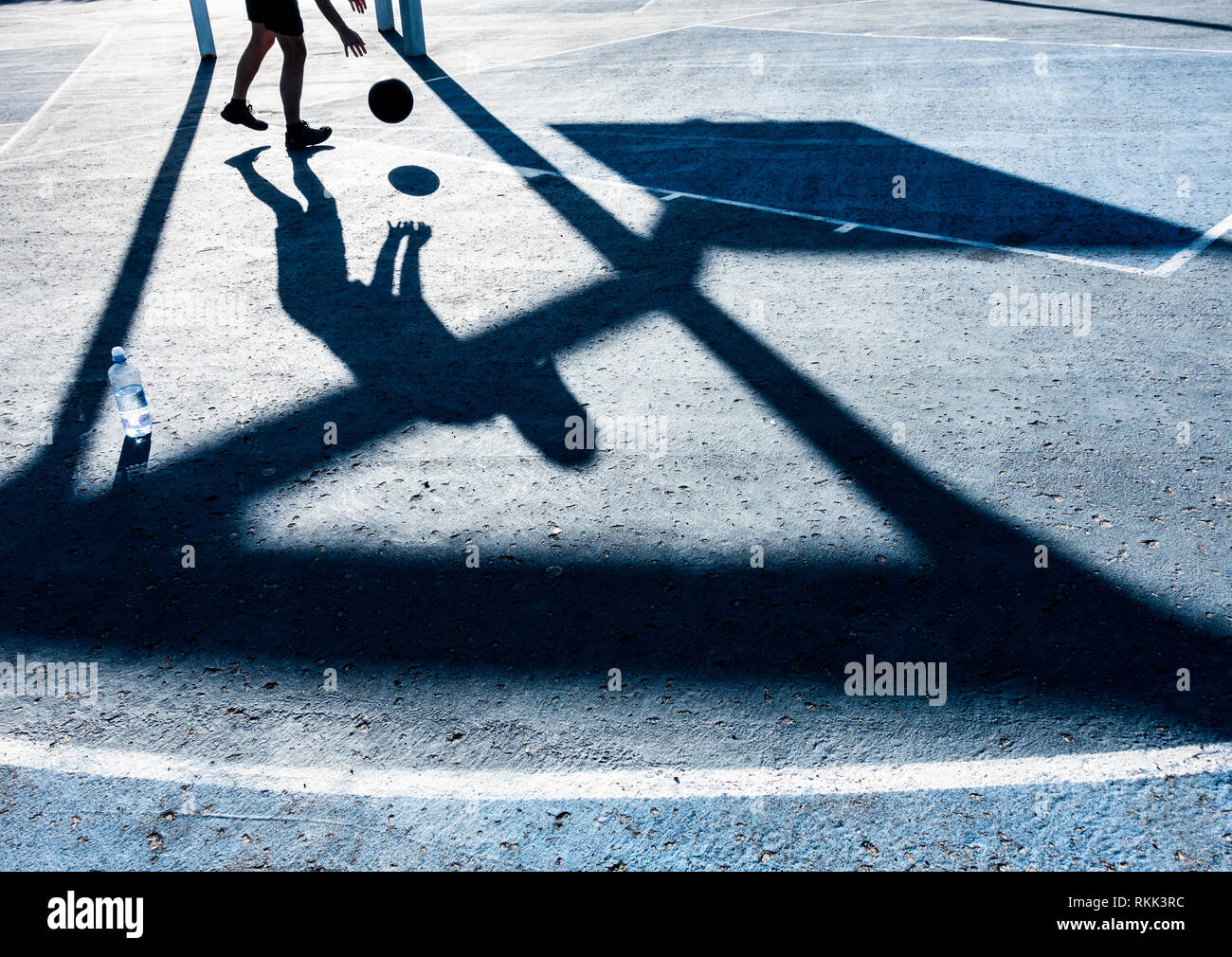 Long shadows on basketball court Stock Photo - Alamy
