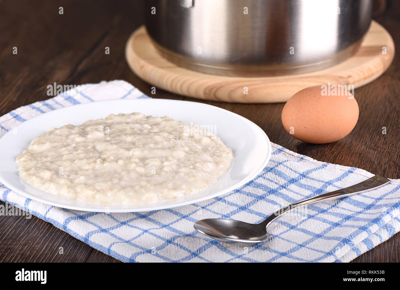 Rustic breakfast with freshly cooked oatmeal and boiled egg Stock Photo ...