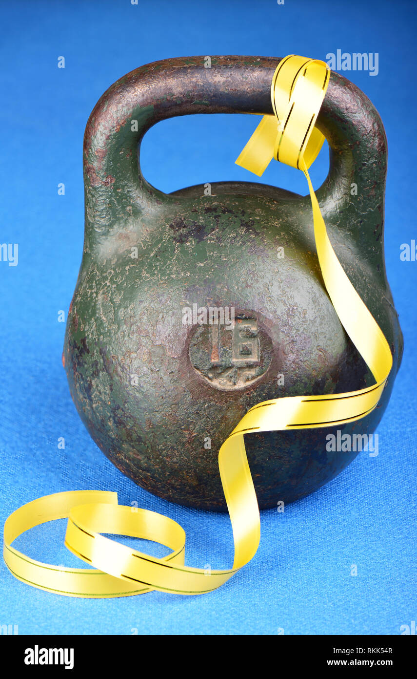 Old kettlebell with gift ribbon. Healthy lifestyle concept Stock Photo ...
