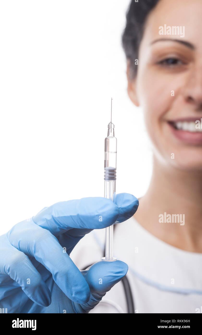 A syringe with an injection solution.The smiling doctor is holding a ...