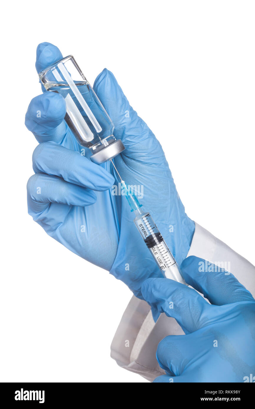 A syringe and a bottle with an injection solution on white background ...