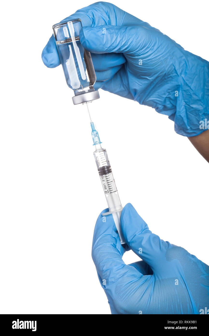 A syringe and a bottle with an injection solution on white background ...
