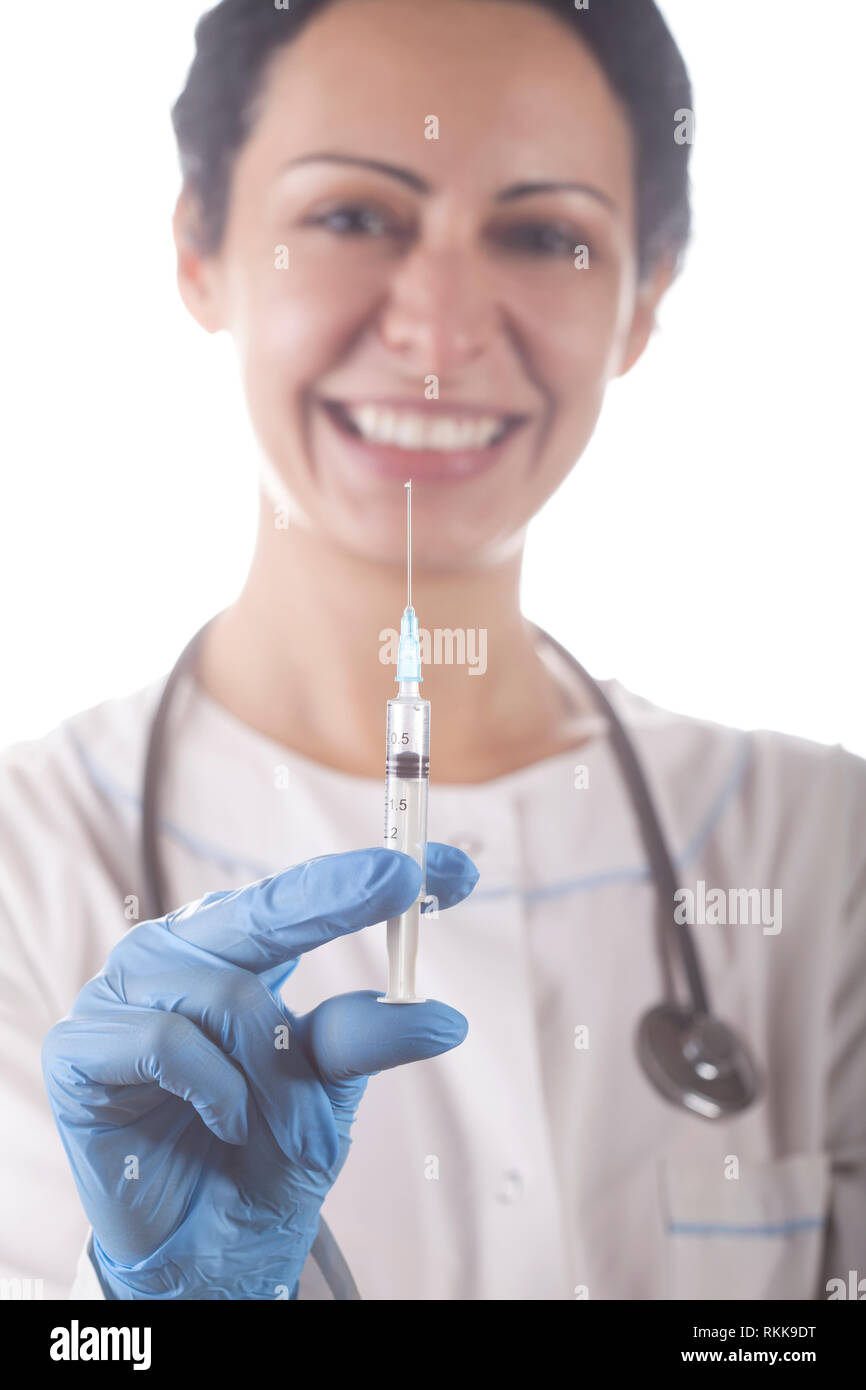 A syringe with an injection solution.The smiling doctor is holding a ...