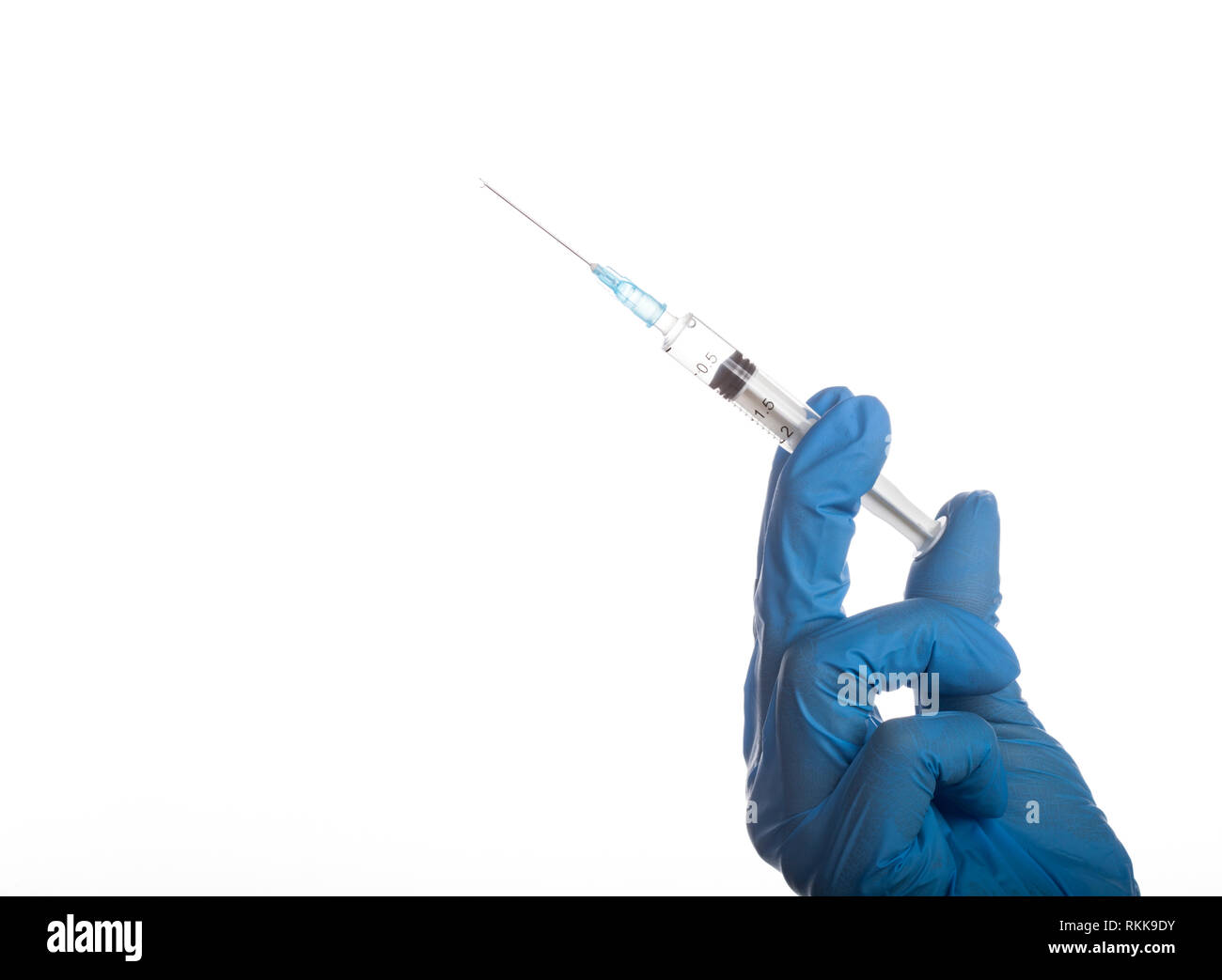 A syringe with an injection solution.The doctor is holding a syringe ...