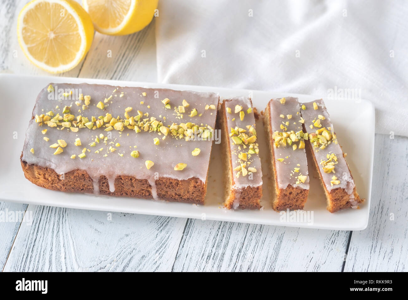 Lemon cake with icing decorated with pistachios: top view Stock Photo ...