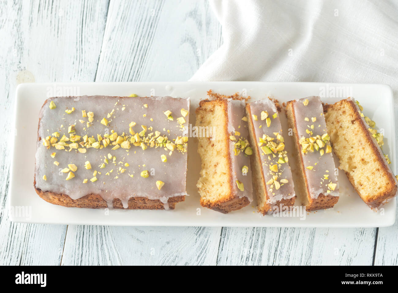 Lemon cake with icing decorated with pistachios: top view Stock Photo ...