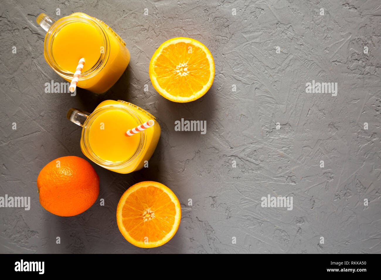 Fresh orange juice in glass jars, top view. From above, overhead. Copy ...