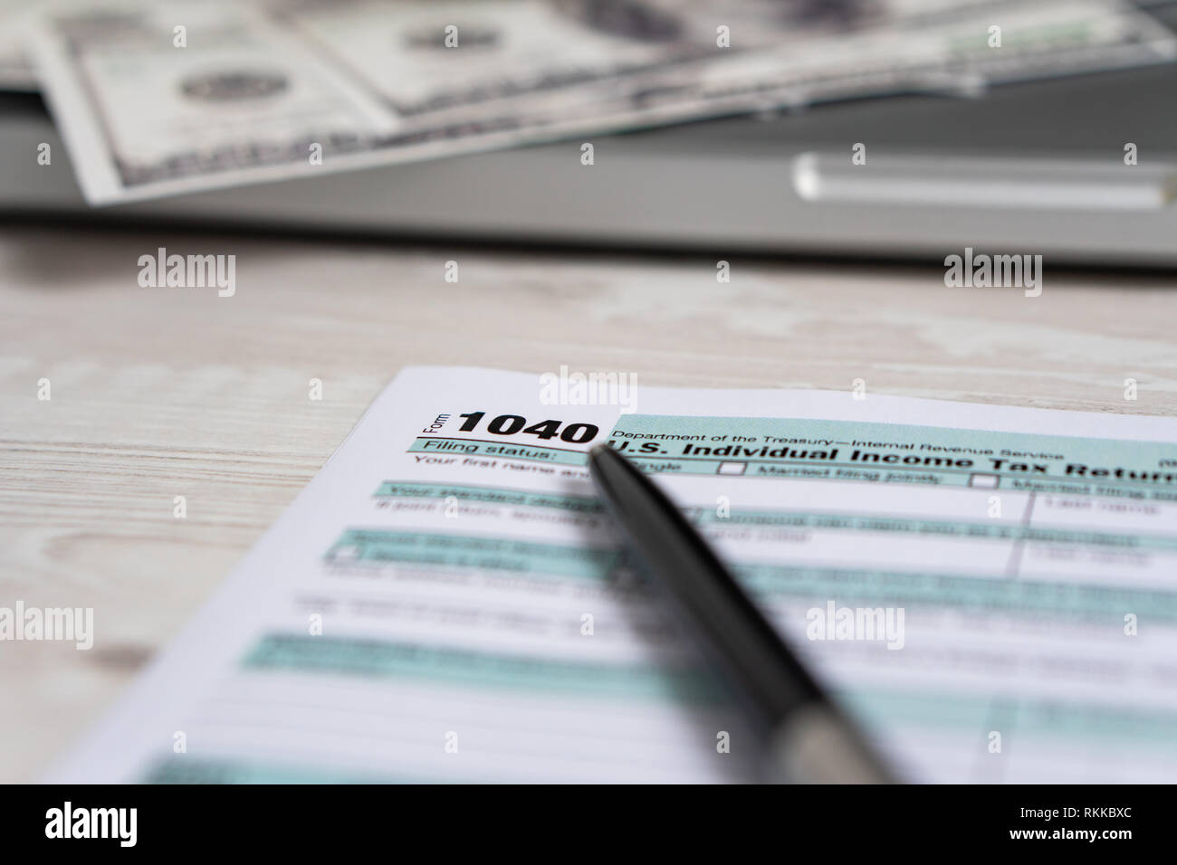 US tax form 1040 with pen and dollar bills. tax form law document usa ...