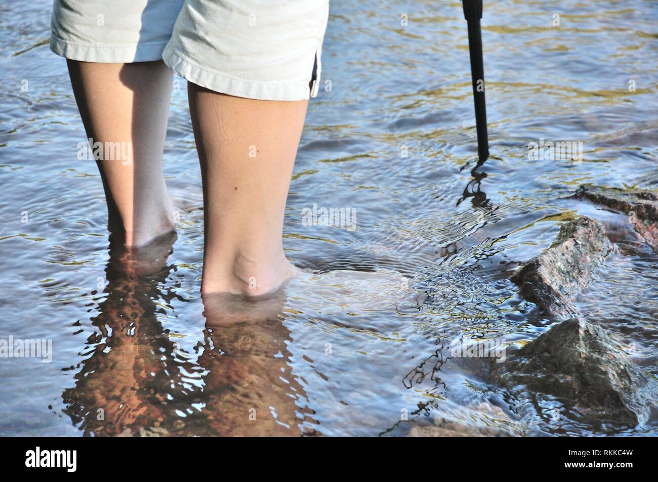 Woman walking by water hi-res stock photography and images - Alamy
