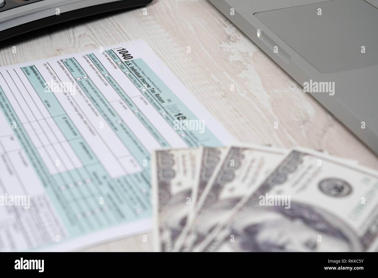 US tax form 1040 with dollar bills. tax form in focus. tax form law ...